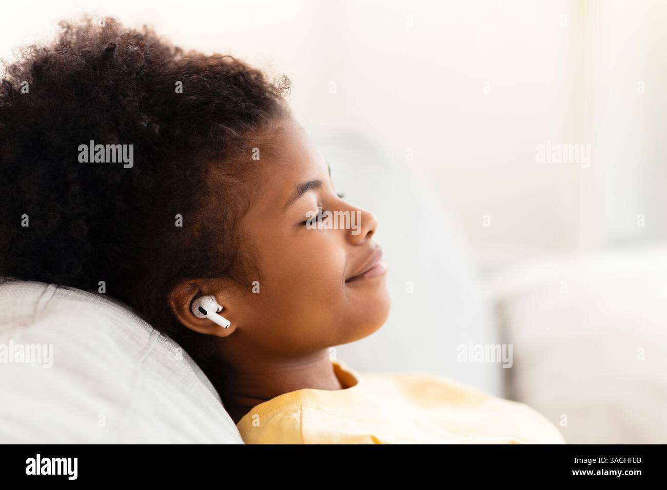 Black Teen Girl Listening Music Wearing Earbuds Relaxing At Home Stock ...