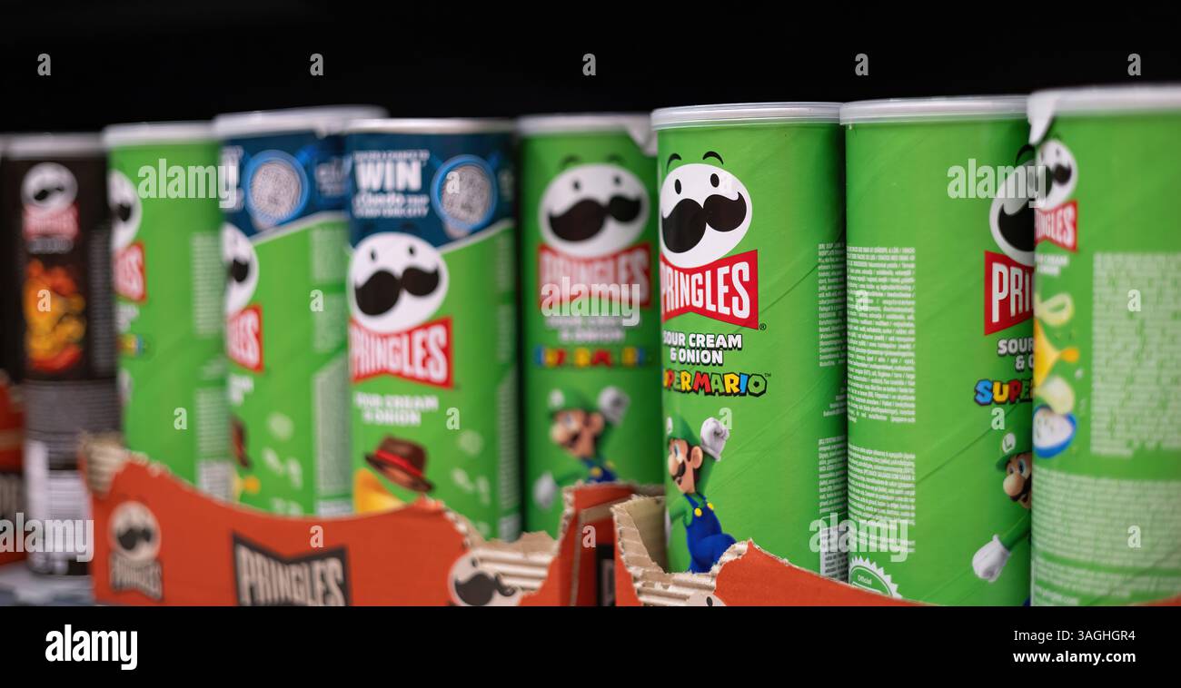 An organized display of Pringles Classic cans, showcasing their iconic ...