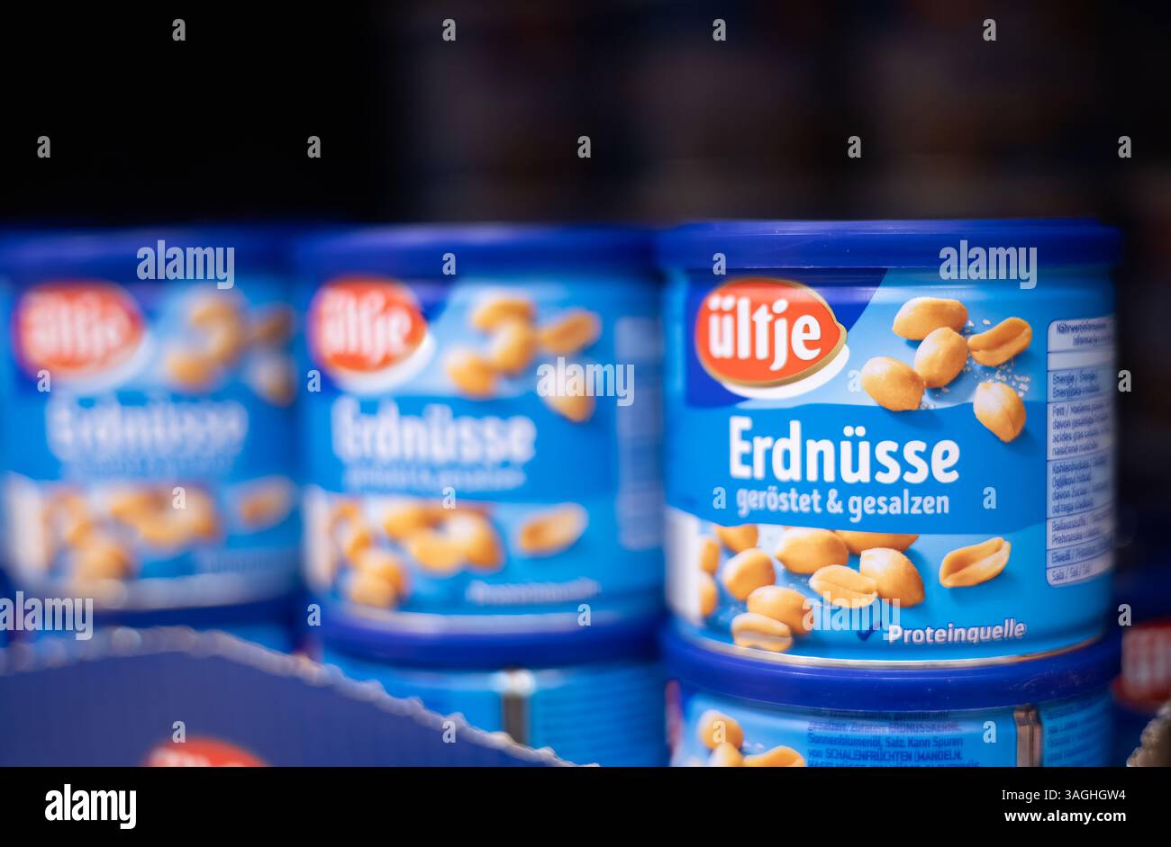 A visually appealing arrangement of roasted salted peanuts in blue ...