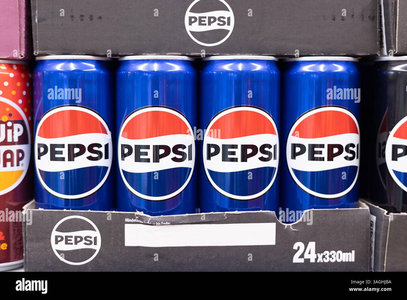 A vibrant display of Pepsi soda cans stacked neatly together ...