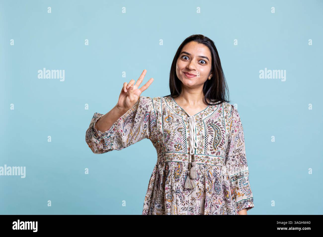 Jolly indian person doing peace sign victory gesture with her hand ...