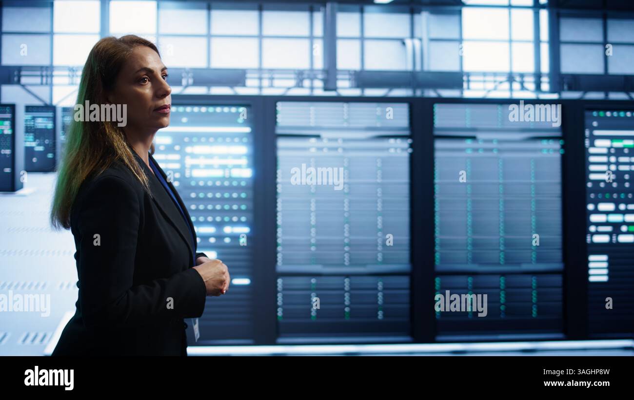 Engineer inspecting server room hardware, walking between supercomputers. IT professional ...