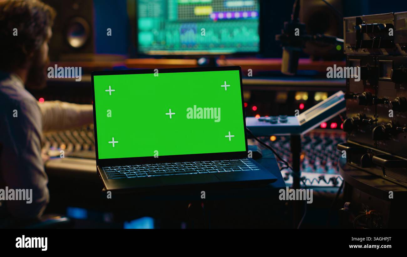 Sound designer uses audio mixer and greenscreen layout in professional ...