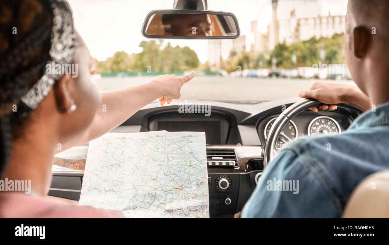 Black woman helping husband driver with road map, showing way Stock ...