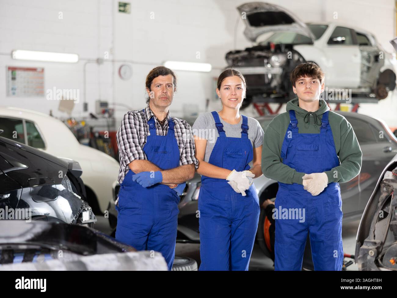 Team of professional auto mechanics posing in car repair shop Stock ...