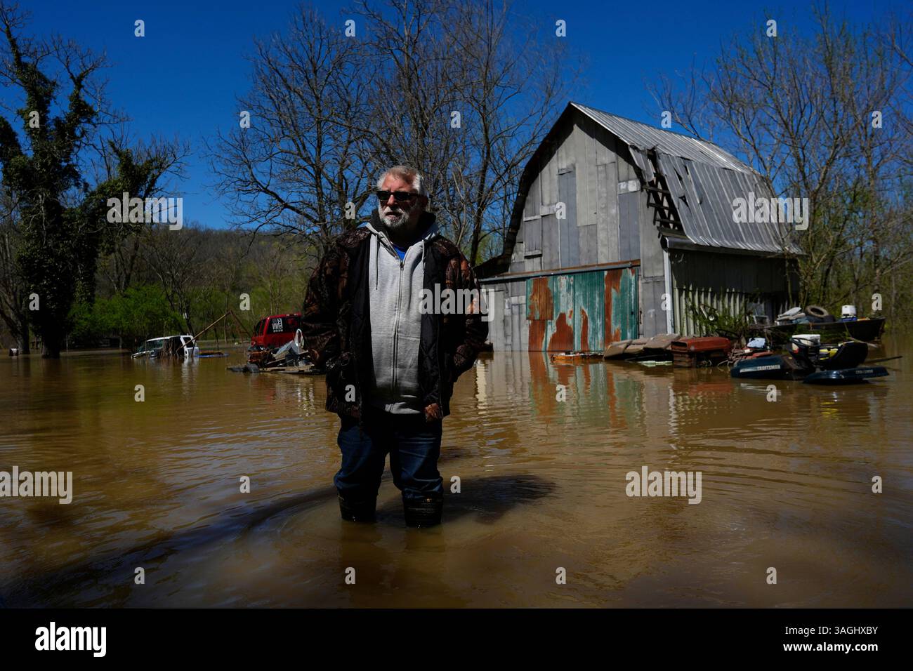 James Harp, Jr., stands in Kentucky River floodwaters in a barnyard in ...