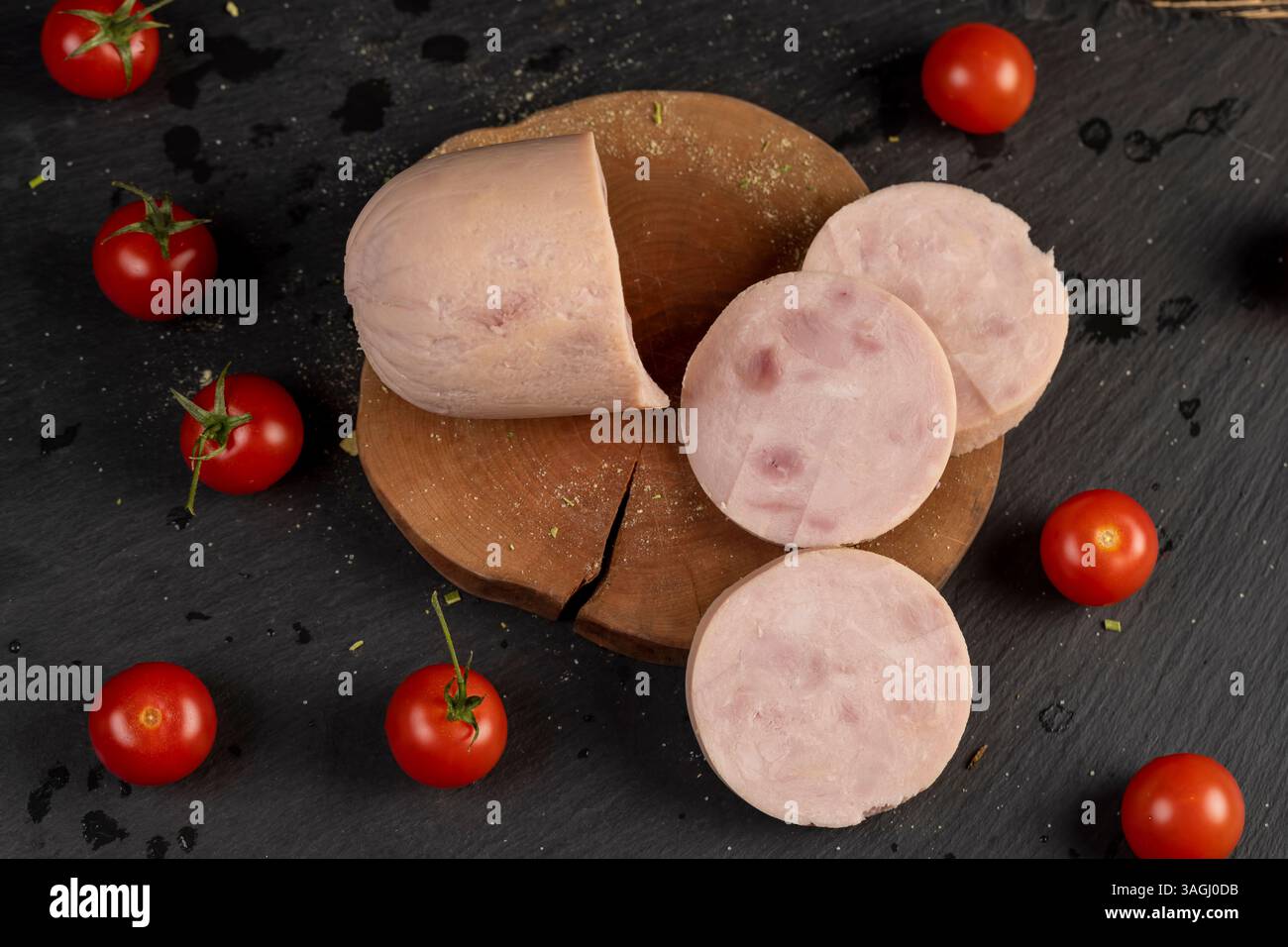 chicken ham and ripe red tomatoes, slicing sausage from chicken fillet ...