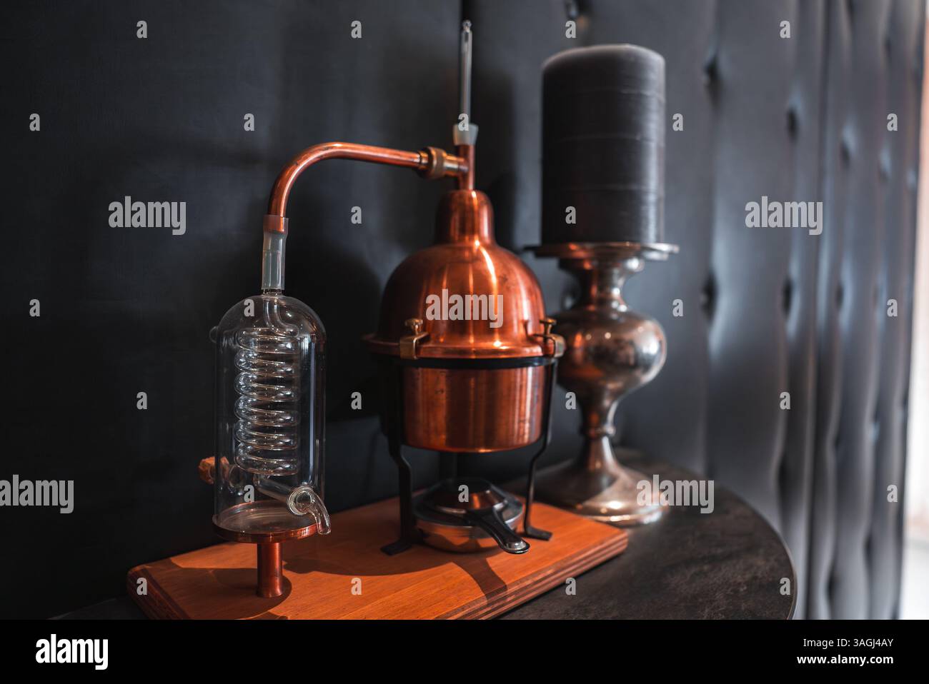 Copper Distillation Apparatus with Candle on Tufted Leather Background ...
