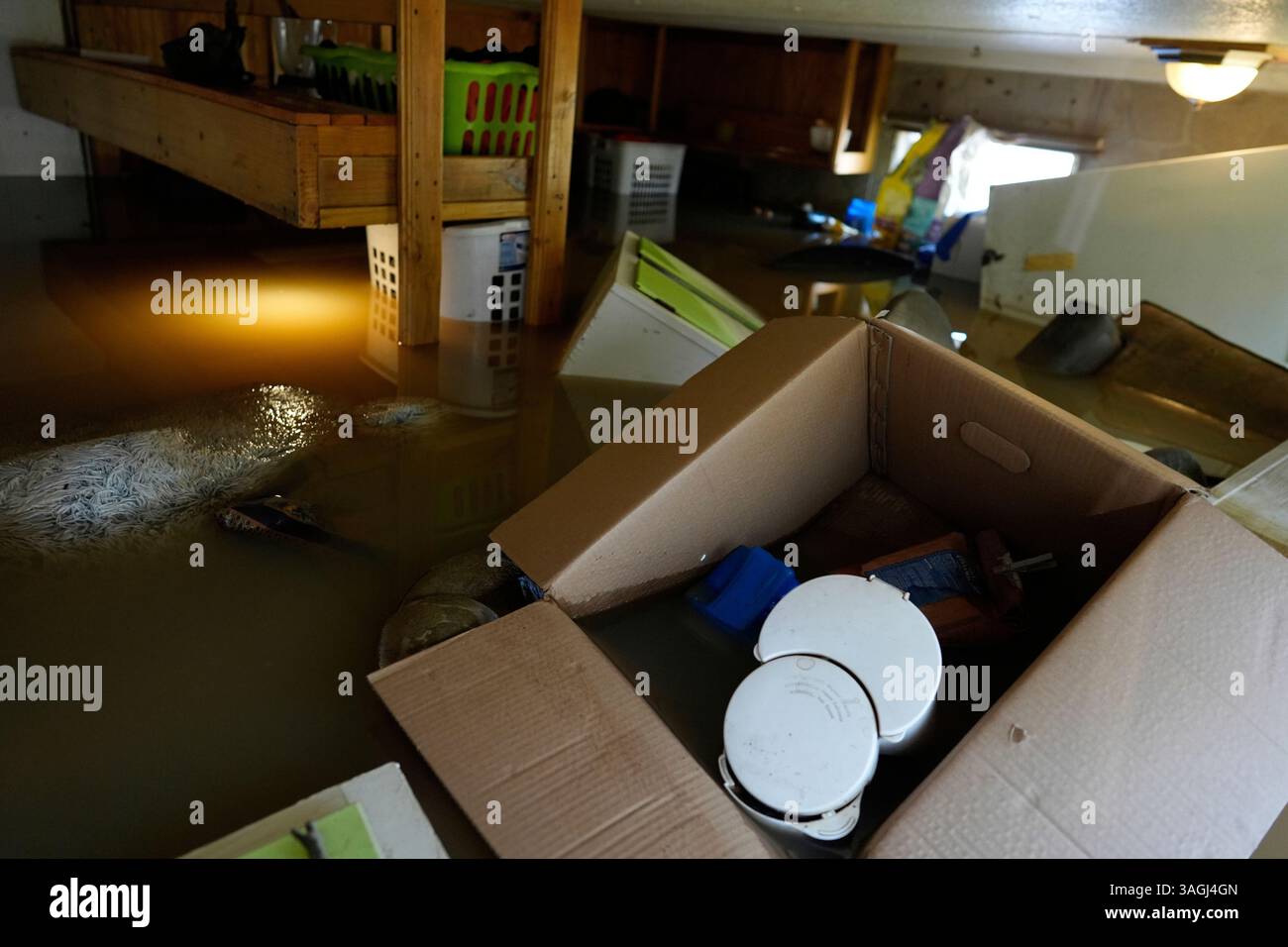 Boxes with personal belongings and kitchen appliances float to the ...