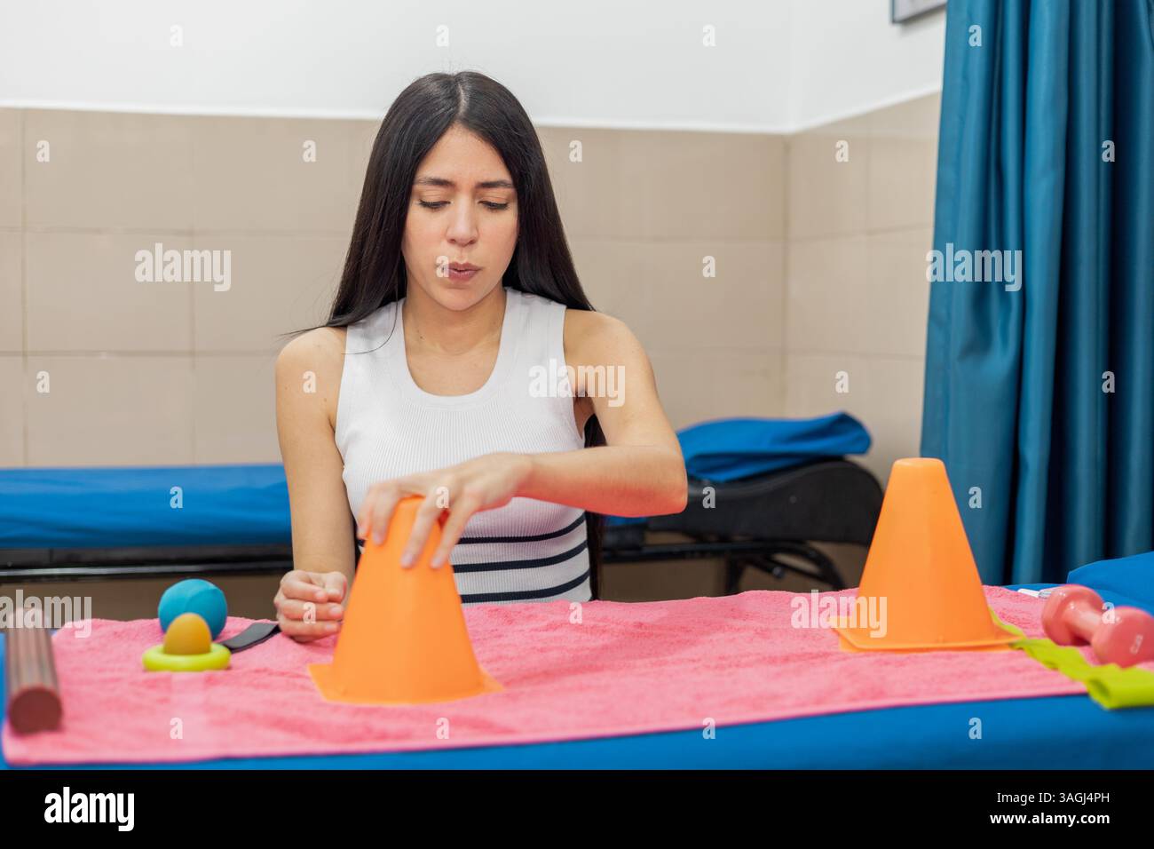 Her hand moves with care, weaving between bright cones—a silent dance ...