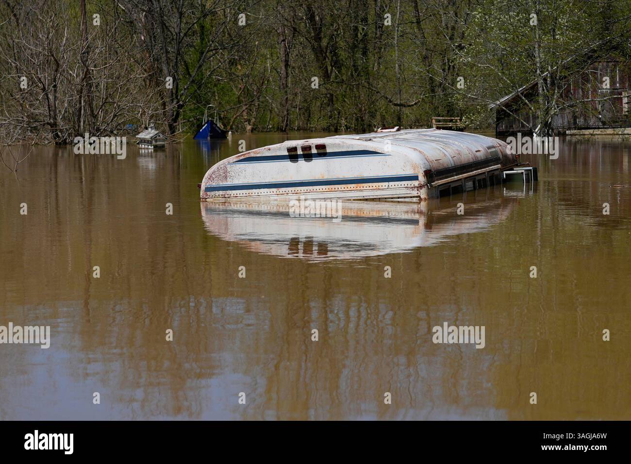 A school bus is flooded by the Kentucky River in Lockport, Ky., Tuesday ...