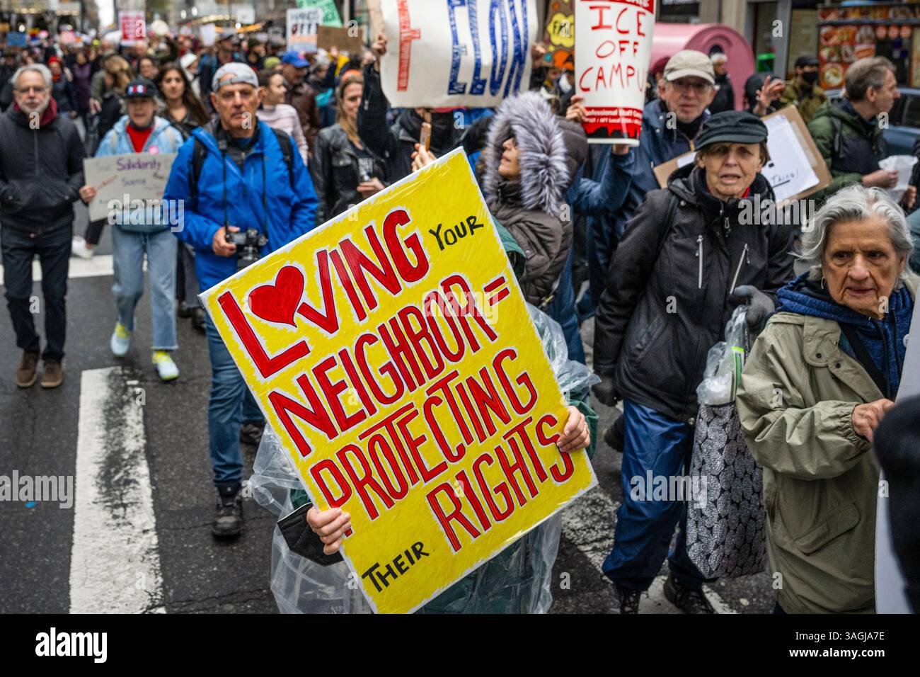Protesters march through downtown Manhattan holding placards expressing ...