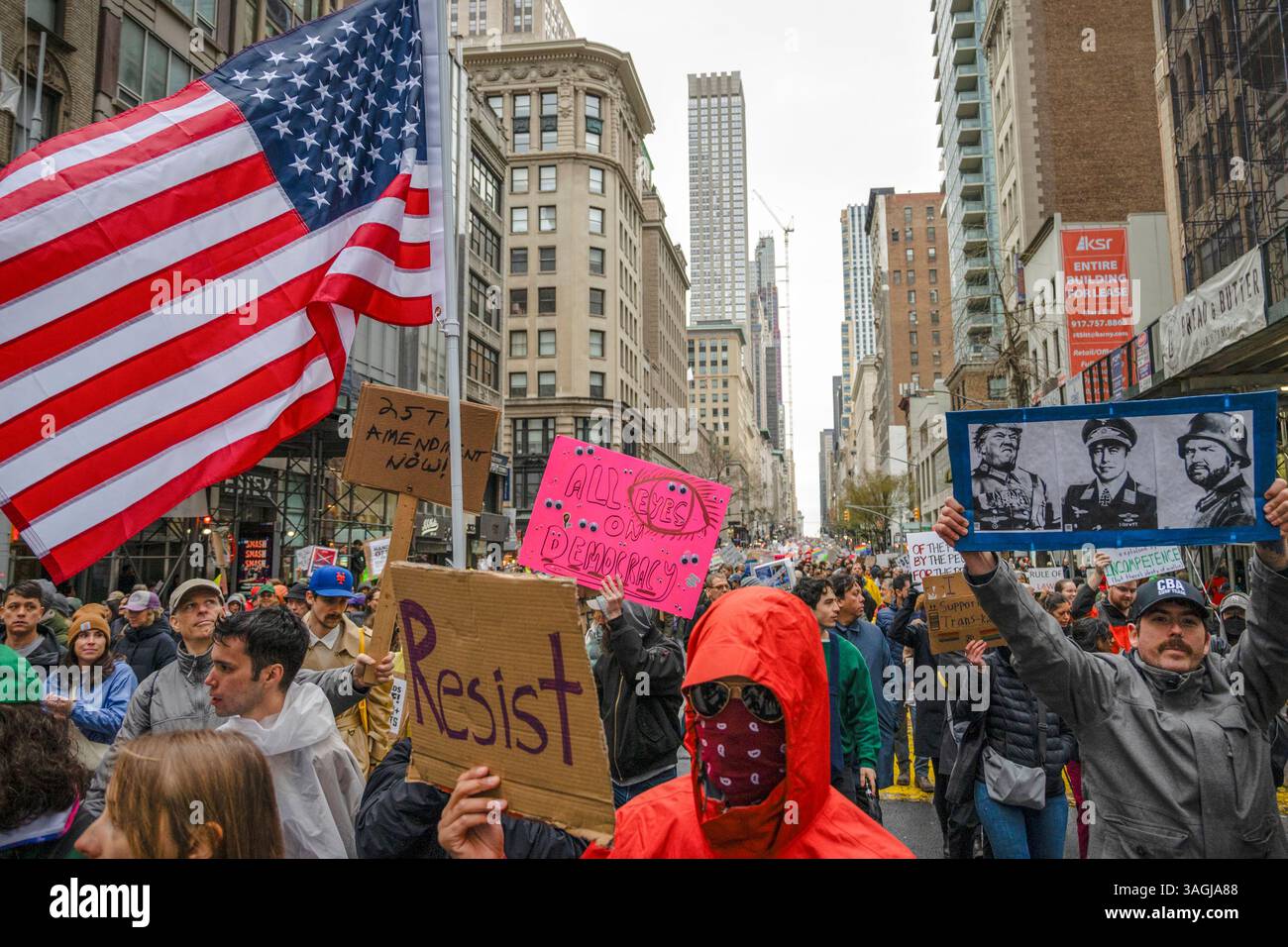 Protesters march through downtown Manhattan holding placards expressing ...