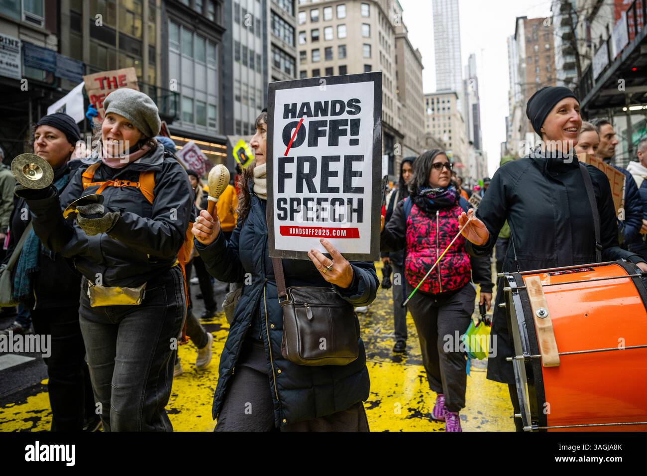 Protesters march through downtown Manhattan holding placards expressing ...