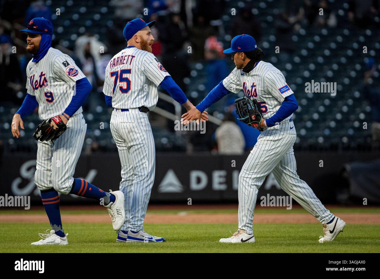 New York Mets' outfielder Tyrone Taylor (15) and pitcher Reed Garrett ...