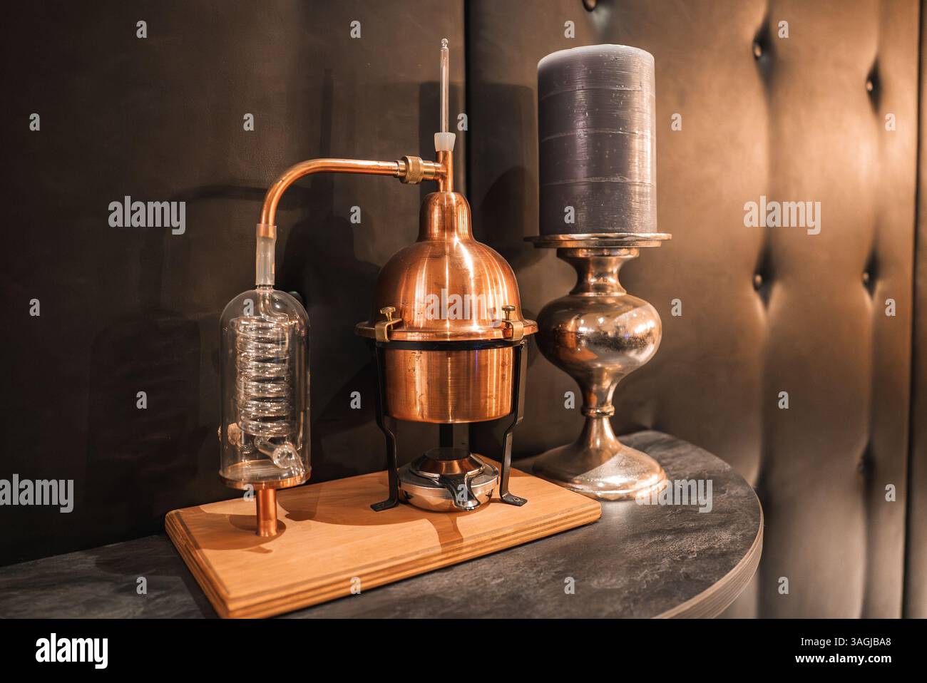 Copper Distillation Apparatus with Candle on Wooden Base Stock Photo ...
