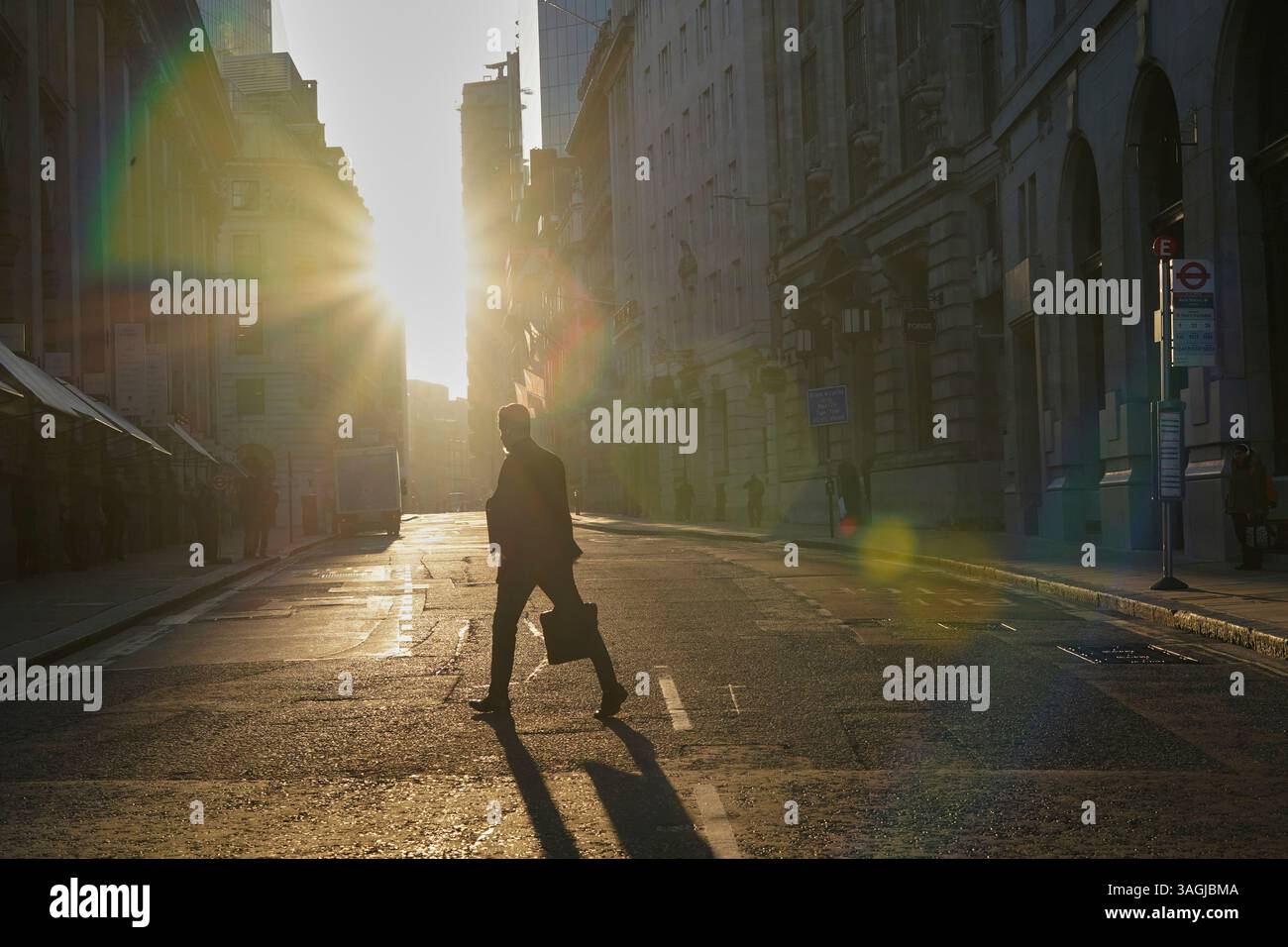 A man walks in the the City of London financial district, London ...