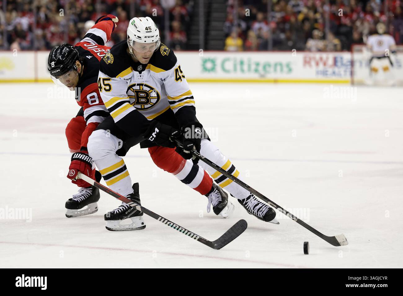 Boston Bruins left wing Cole Koepke (45) battles for control of the ...