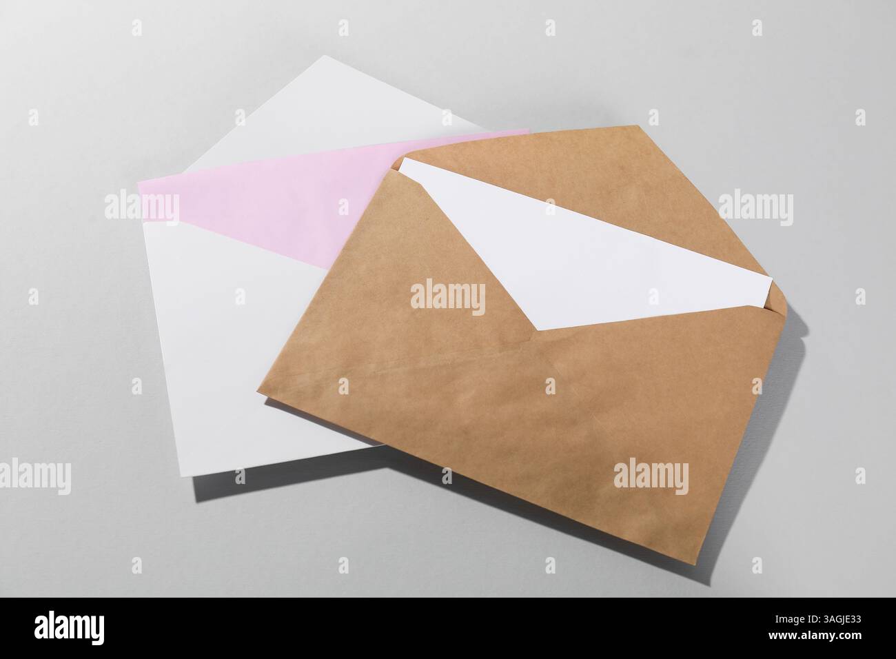 Paper envelopes with letters on grey background, above view. Mockup for ...