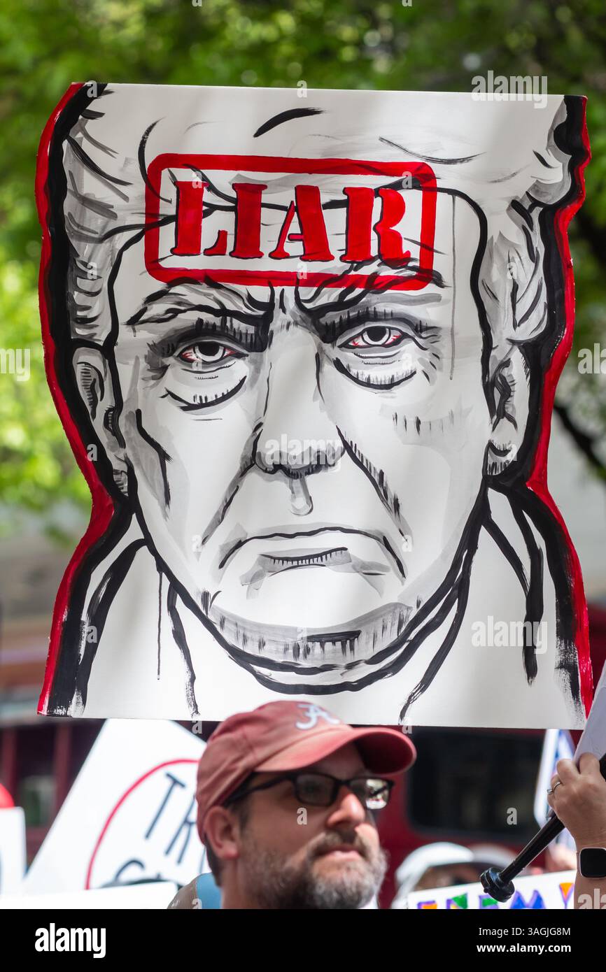 Atlanta, GA / USA - April 5, 2025: Protestor holds sign labeling Trump ...