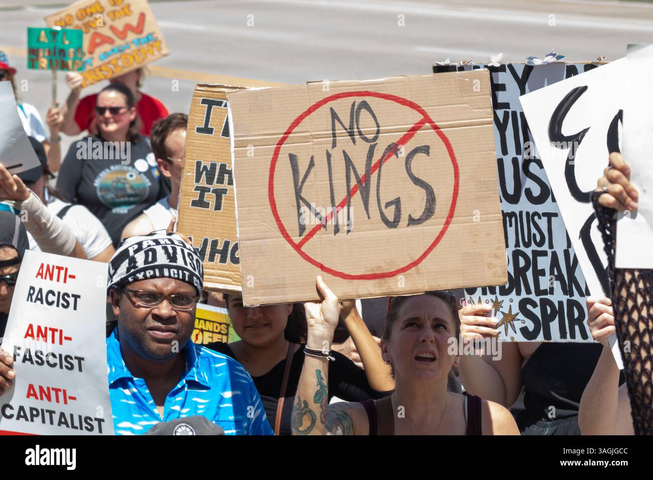 Atlanta, GA / USA - April 5, 2025: Woman holds sign reading "No Kings ...