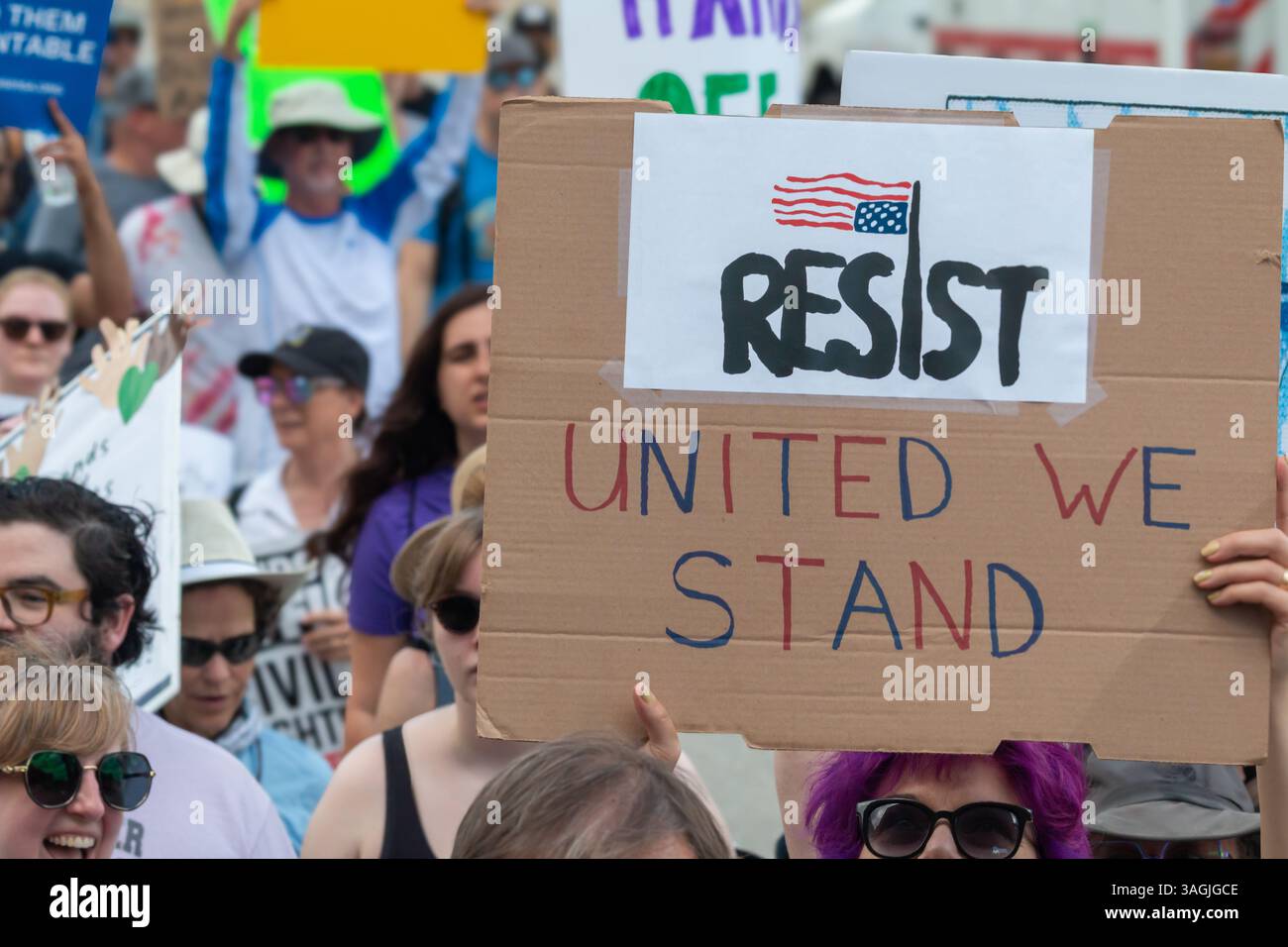 Atlanta, GA / USA - April 5, 2025: Woman holds sign reading "Resist ...