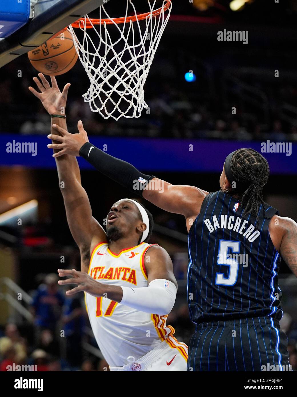Atlanta Hawks forward Onyeka Okongwu, left, shoots over Orlando Magic ...