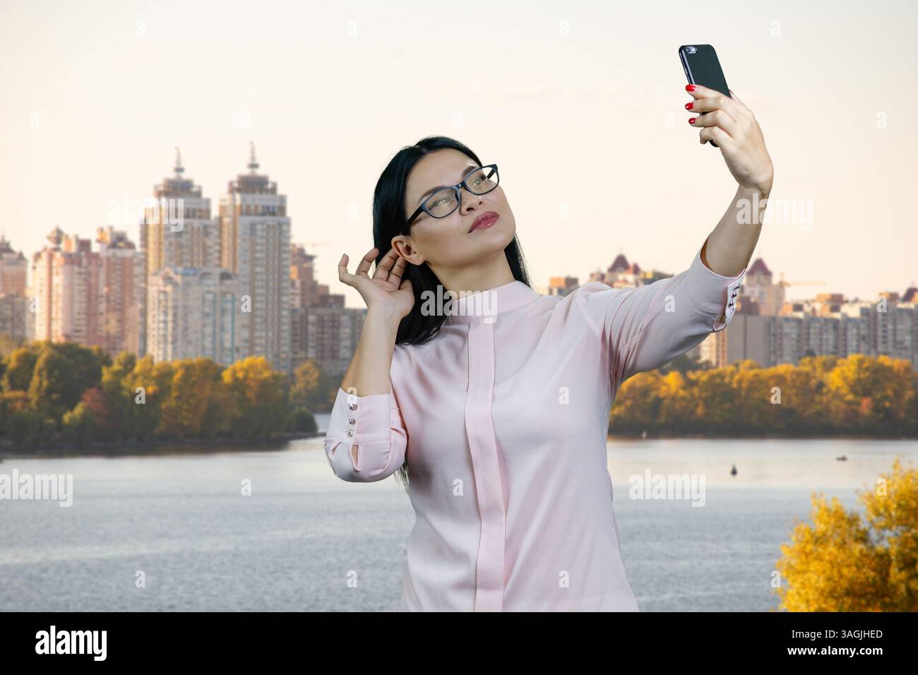 Portrait of a young korean woman taking a selfie on her smartphone ...