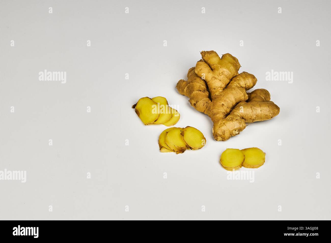 Fresh ginger root with peel isolated on white background with space for ...