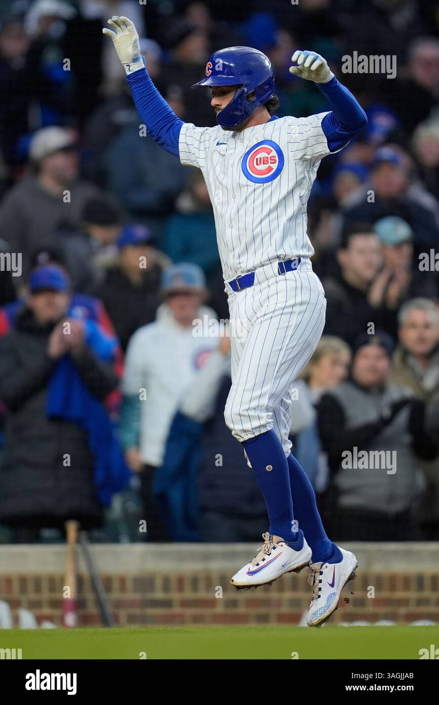 Chicago Cubs' Dansby Swanson (7) hops onto home base after hitting a ...