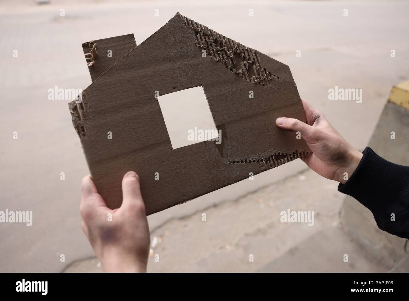 Homeless man with carton house figure outdoors, closeup Stock Photo - Alamy