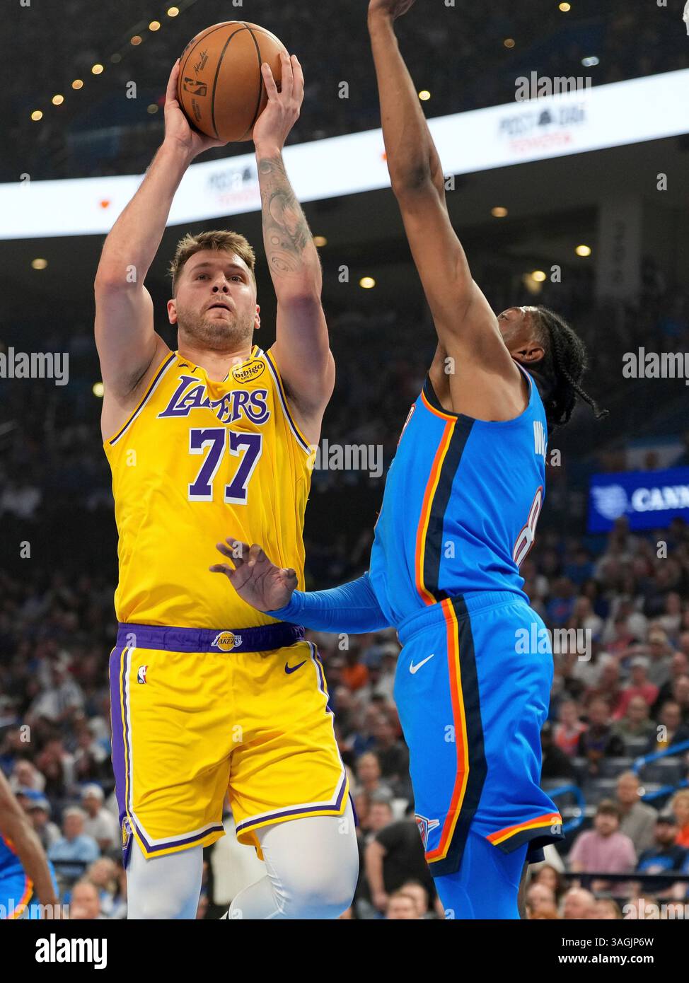 Los Angeles Lakers guard Luka Doncic, left, shoots over Oklahoma City ...
