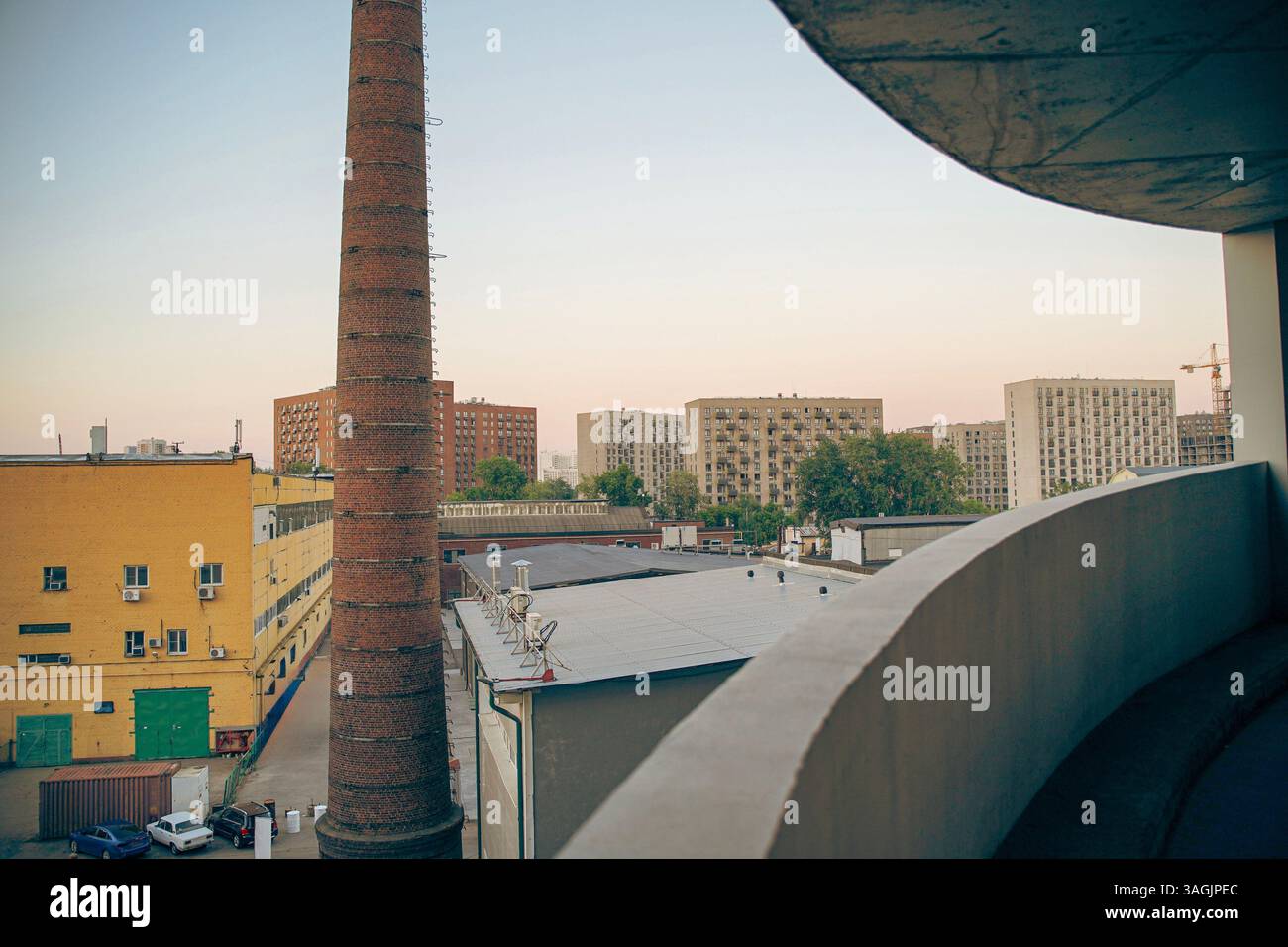 Urban landscape with Soviet-era apartment blocks, a tall red-brick ...