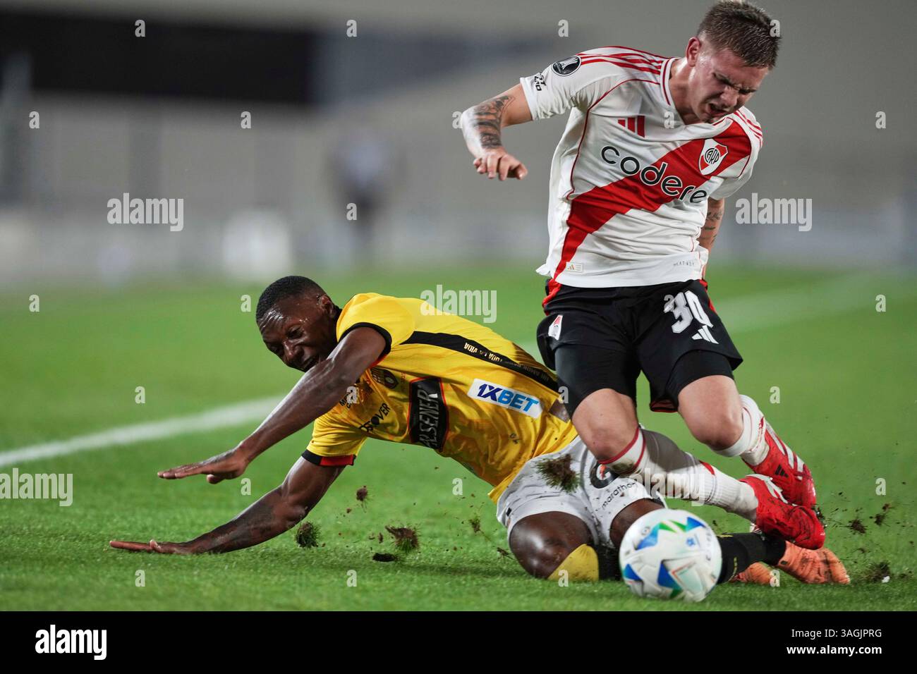 Anibal Chala of Ecuador's Barcelona, left, tackles Franco Mastantuono ...