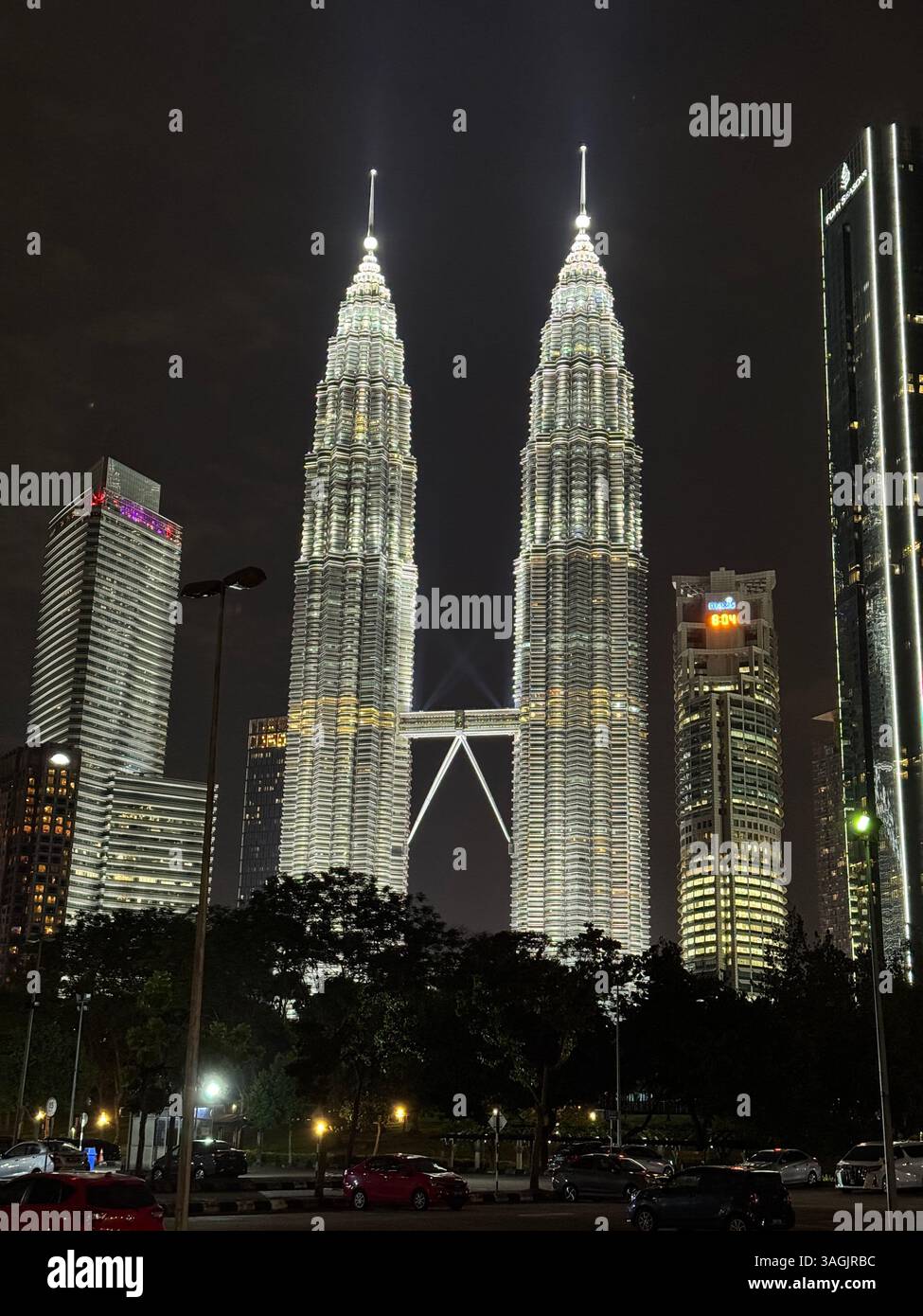 Petronas Towers glowing at night in Kuala Lumpur. Iconic modern ...