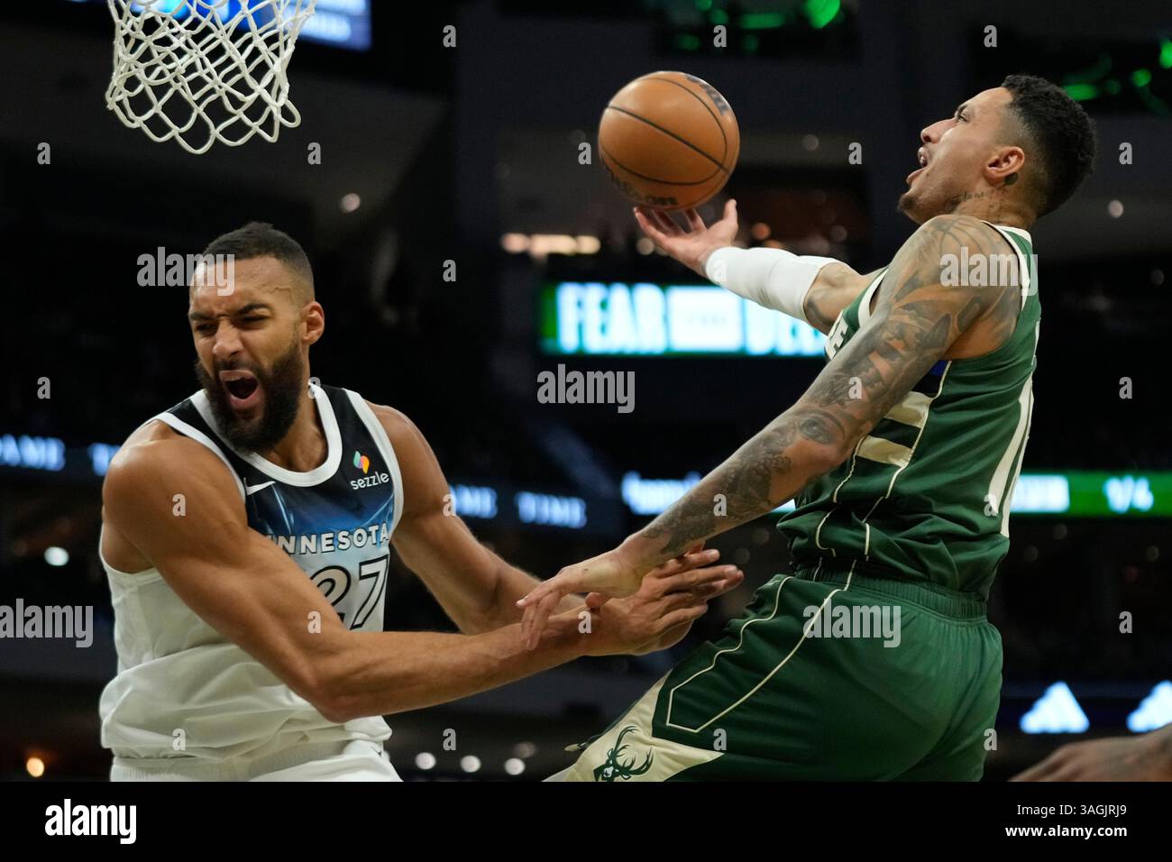 Milwaukee Bucks' Kyle Kuzma, right, commits an offensive foul against ...