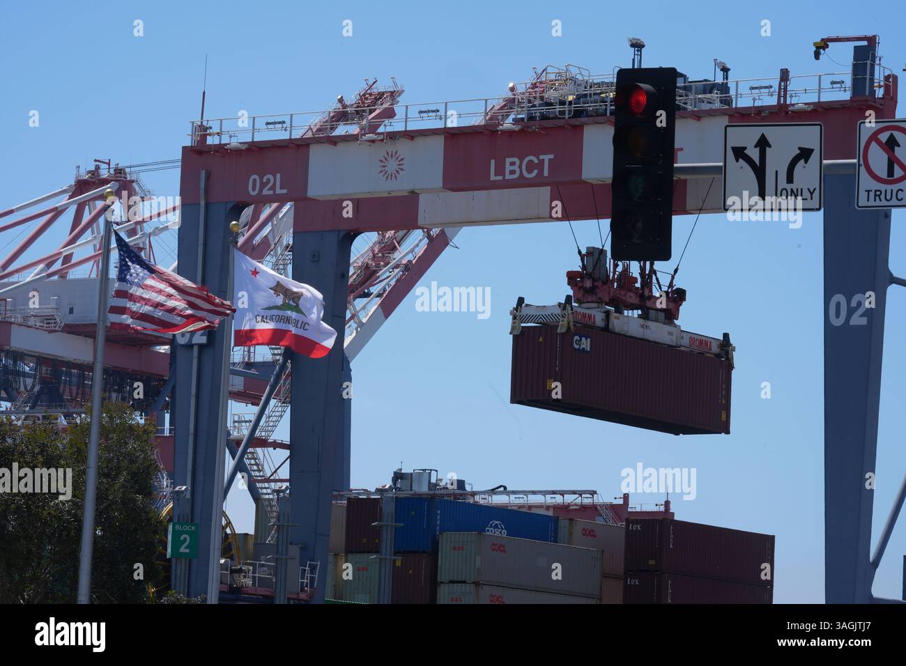 Shipping containers are processed at the Long Beach Container Terminal ...