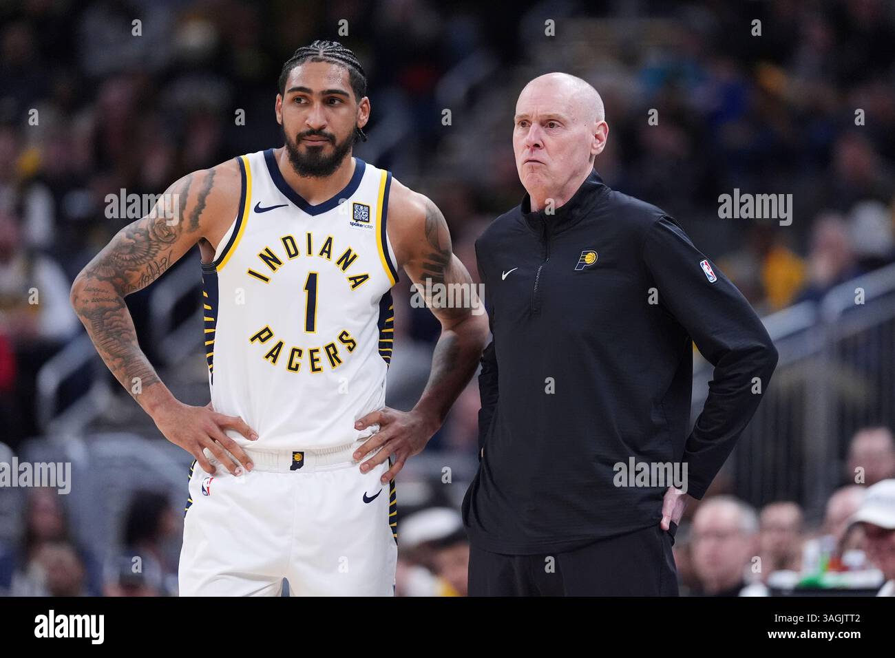 Indiana Pacers head coach Rick Carlisle, right, talks with forward Obi ...