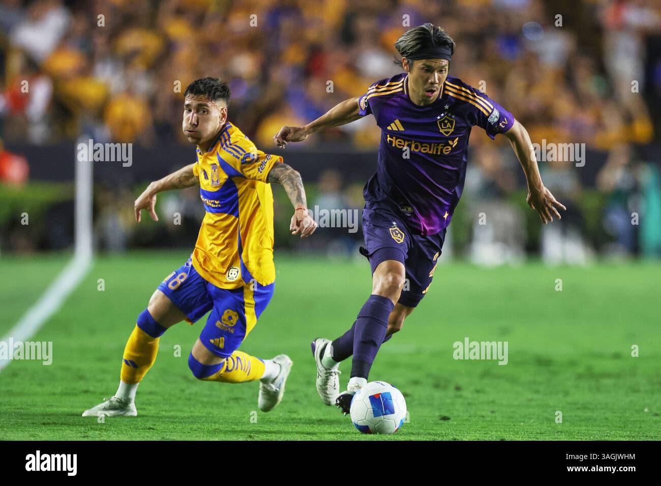 Miki Yamane of the United States' LA Galaxy, right, dribbles past ...