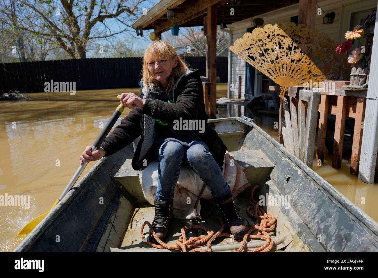 Wanona Harp paddles from her neighbor's front porch in Lockport, Ky ...