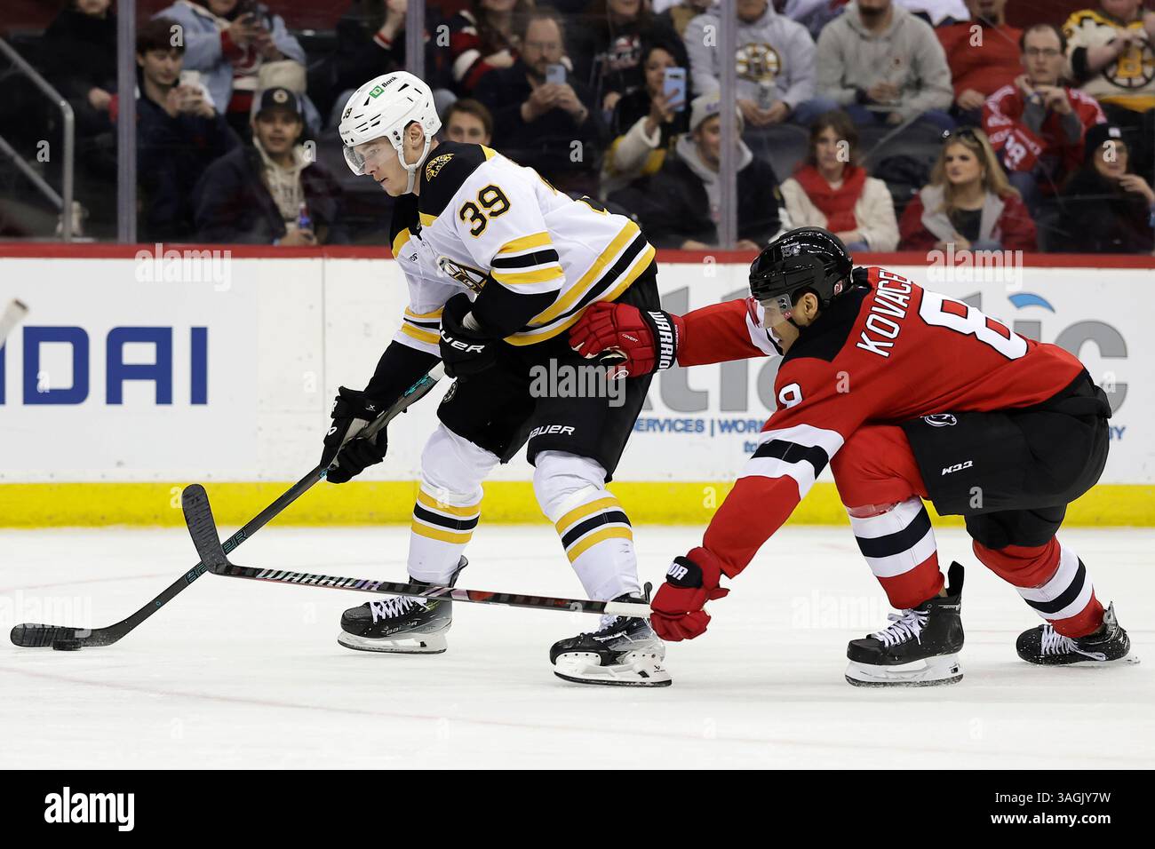 Boston Bruins center Morgan Geekie (39) controls the puck past New ...