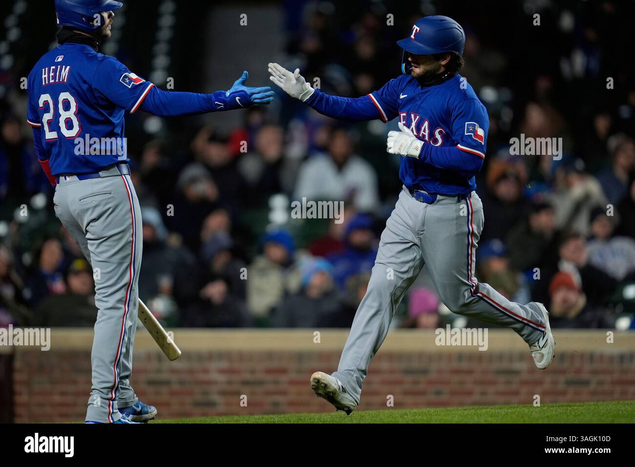 Texas Rangers' Josh Smith (8), right, high-fives Jonah Heim as Smith ...