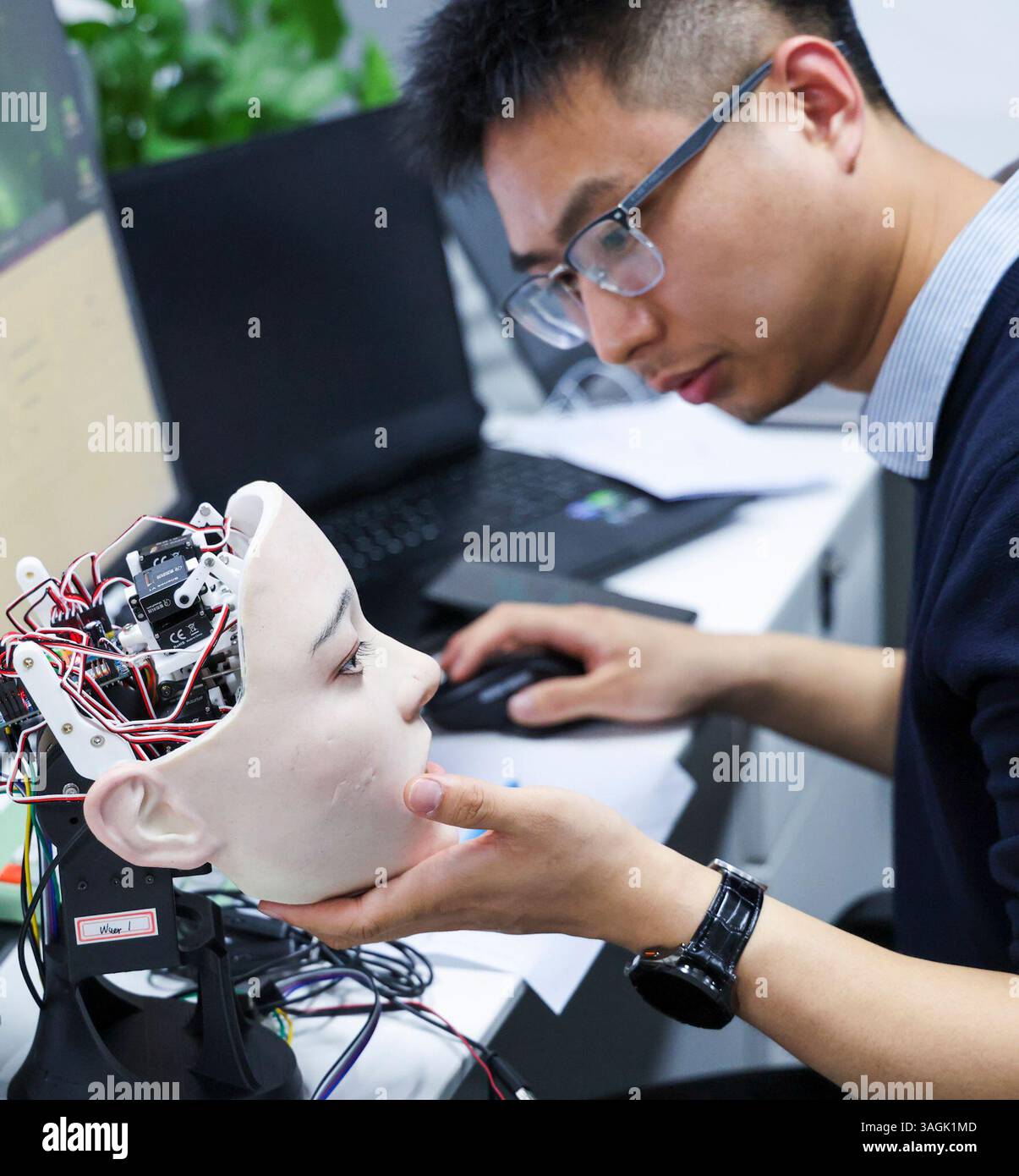 Beijing, China's Guangdong Province. 27th Mar, 2025. A staff member ...
