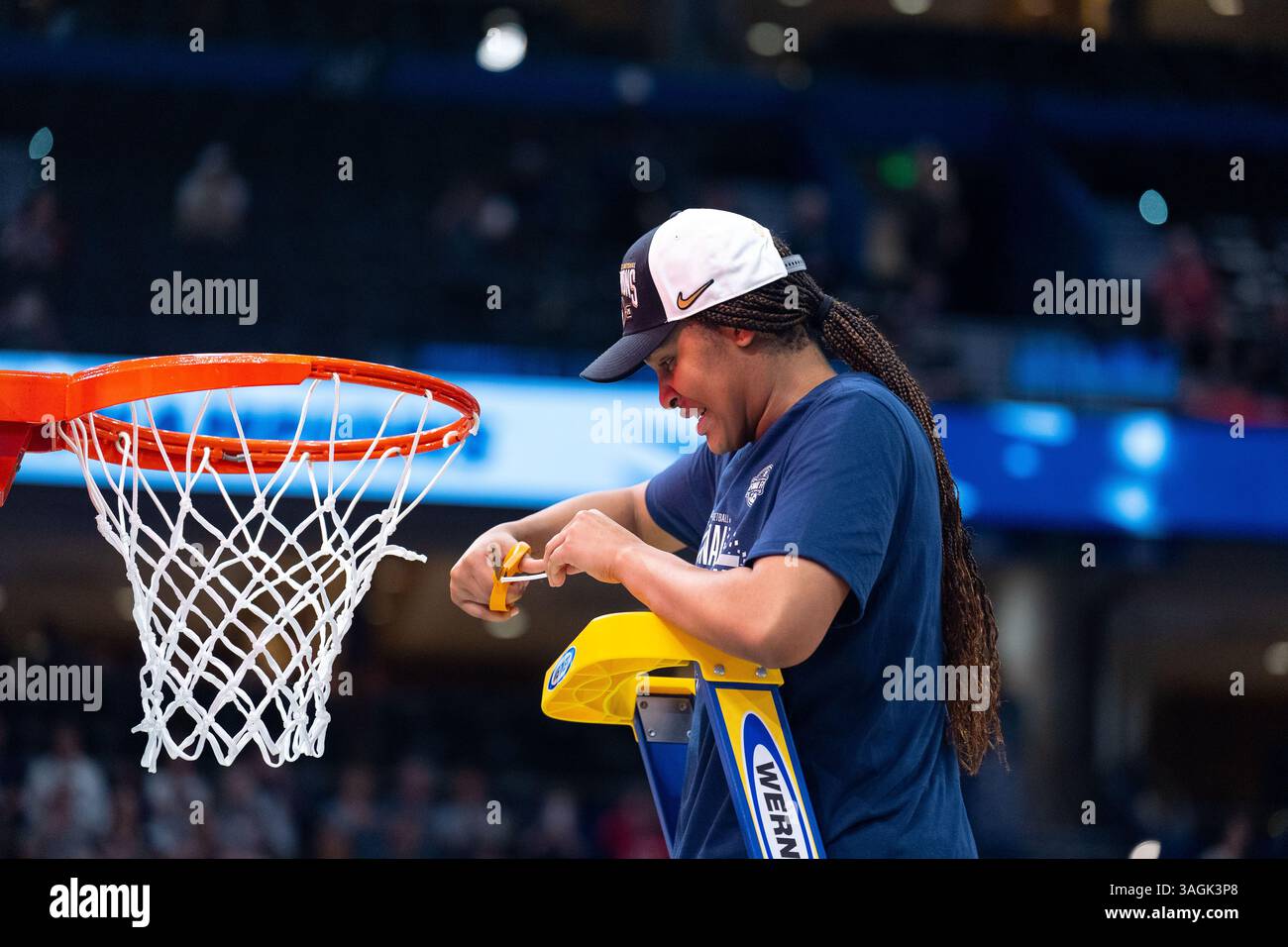 UConn forward Chloe Kitts (21) cuts the net after the championship game ...