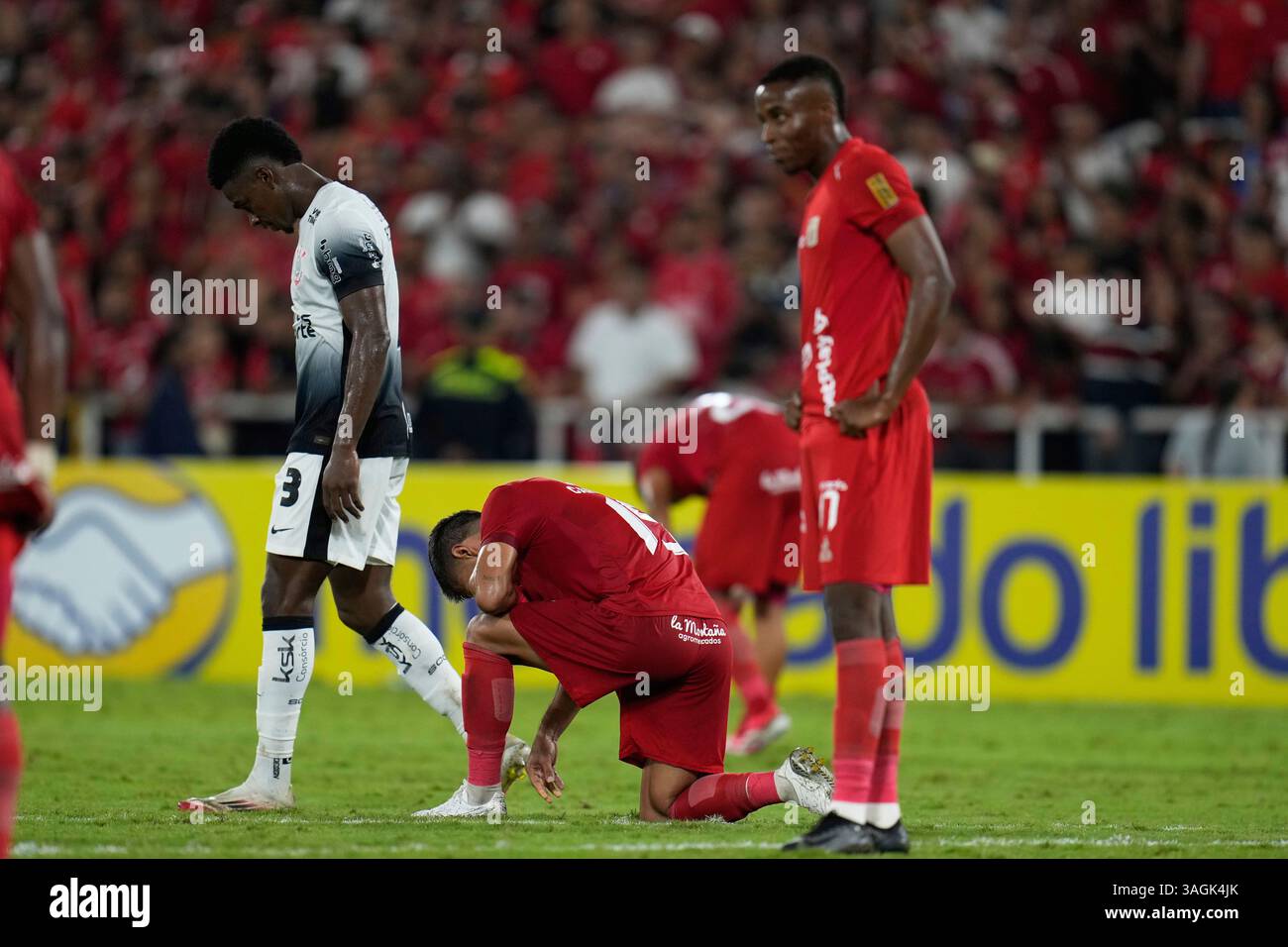 Rafael Carrascal of Colombia's America knees at the end of a Copa ...