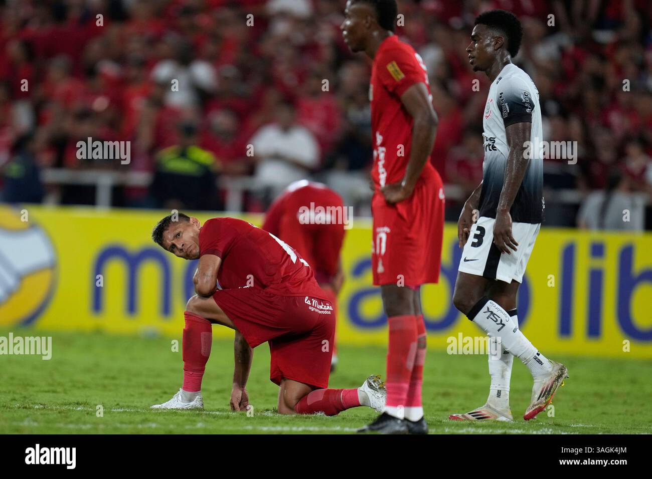 Rafael Carrascal of Colombia's America knees at the end of a Copa ...