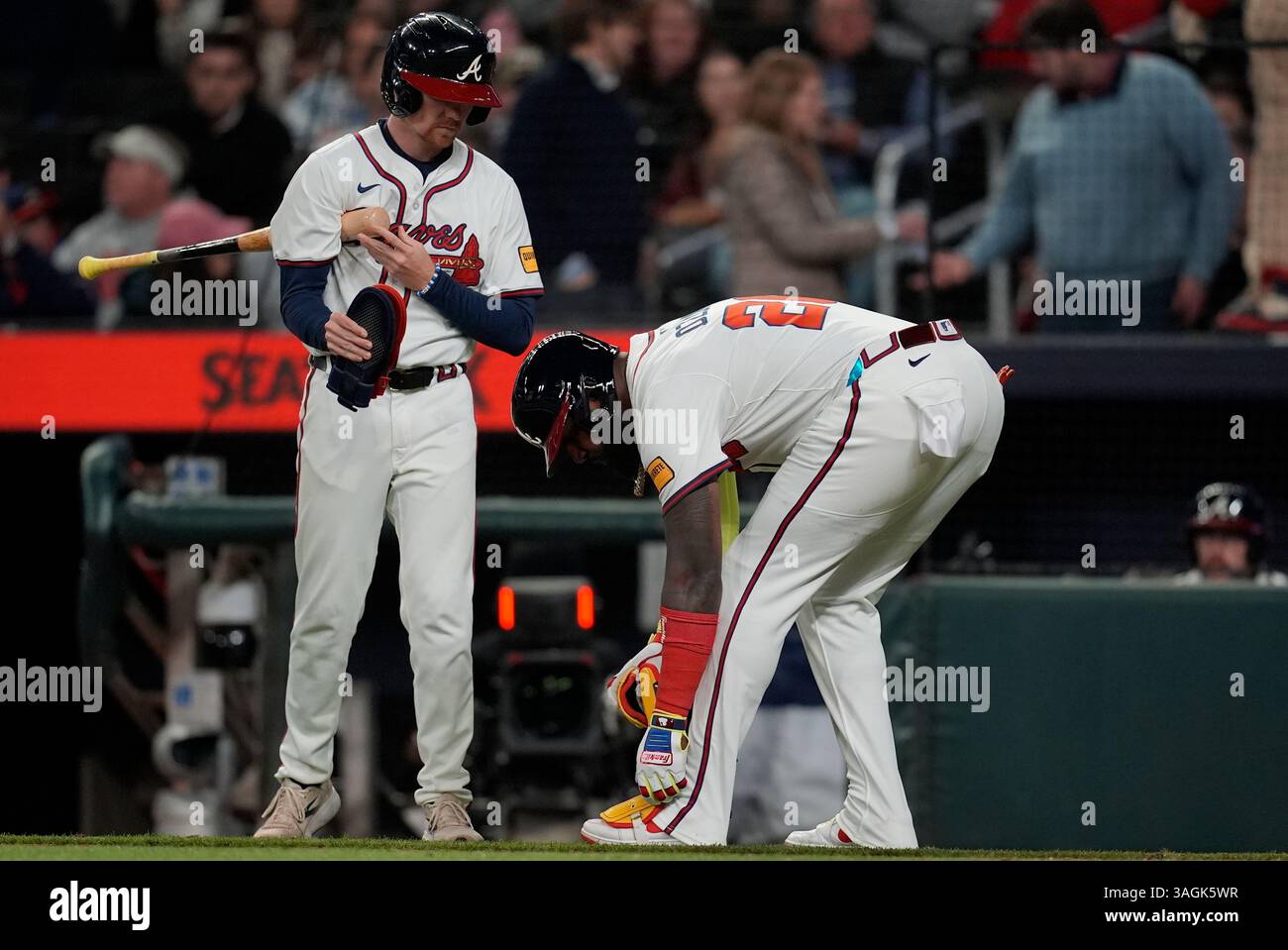 Atlanta Braves designated hitter Marcell Ozuna (20) takes off his gear ...