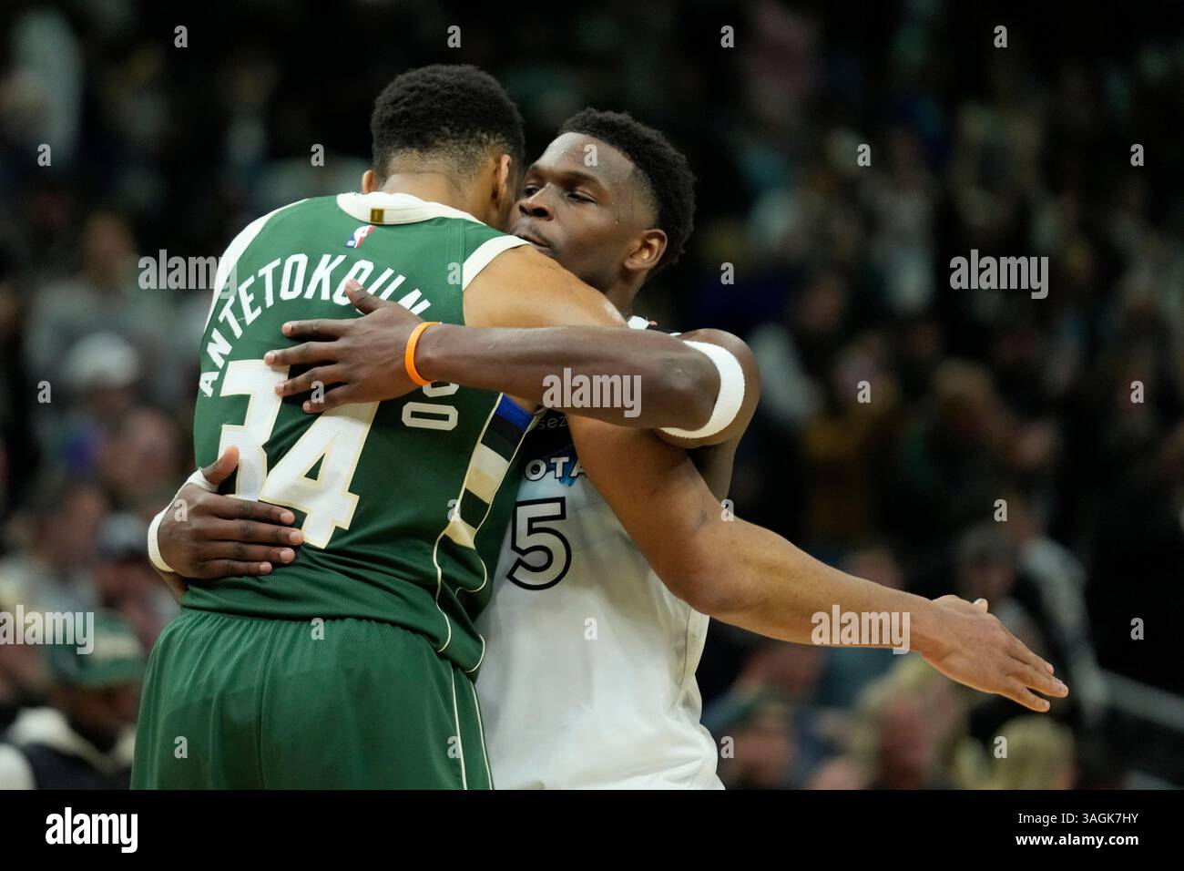 Minnesota Timberwolves' Anthony Edwards (5) hugs Milwaukee Bucks ...