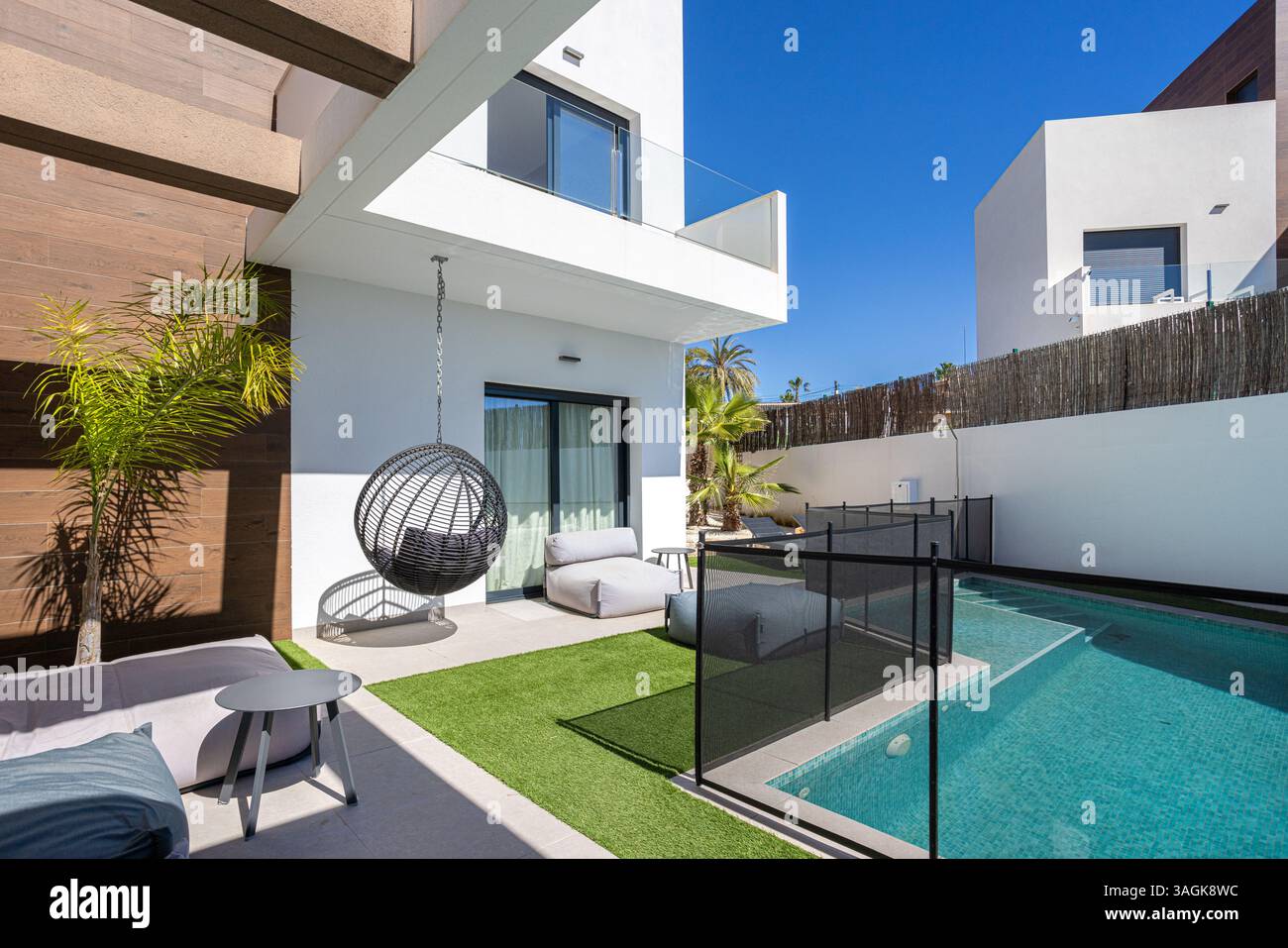 Exterior view of a modern luxury villa with a private pool, hanging ...