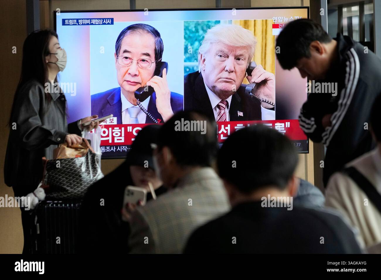 People watch a TV screen showing a file image of South Korean acting ...